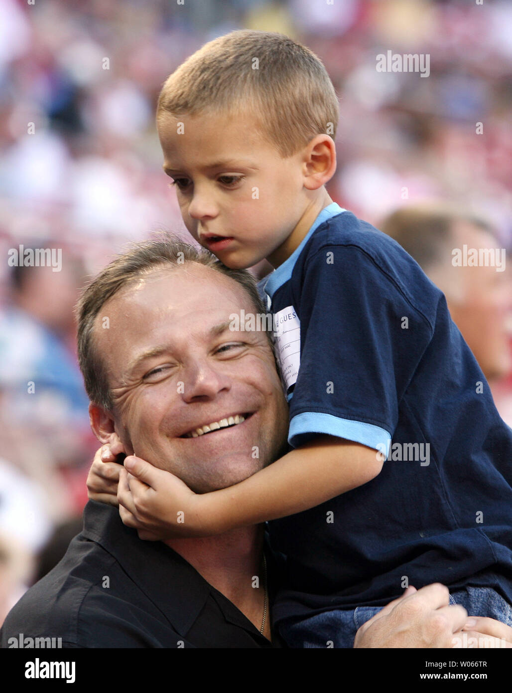 St. Louis Rams head football coach Scott Linehan holds on to son Marcus ...