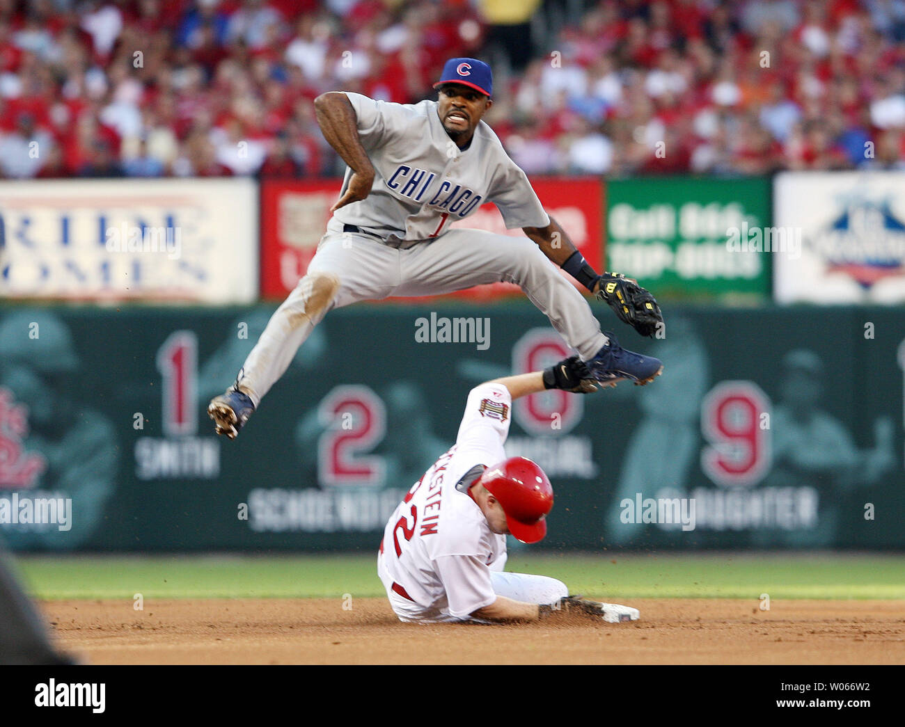 Chicago Cubs Tony Womack jumps to avoid the sliding St. Louis Cardinals ...