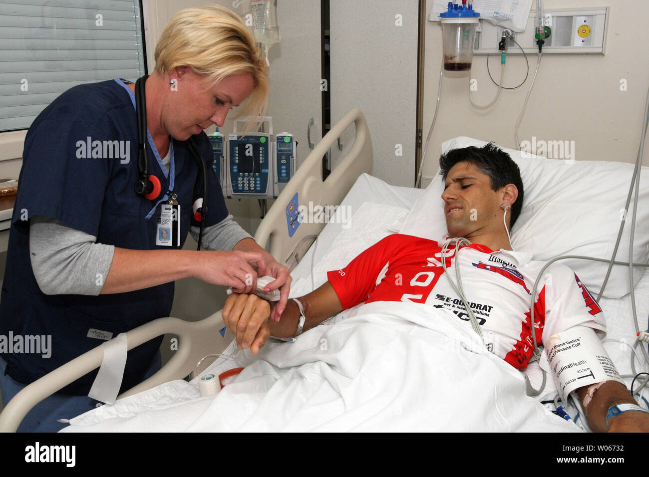 Swiss bicyclist Daniel Maegerie grimaces as nurse dawn Johnson inserts ...