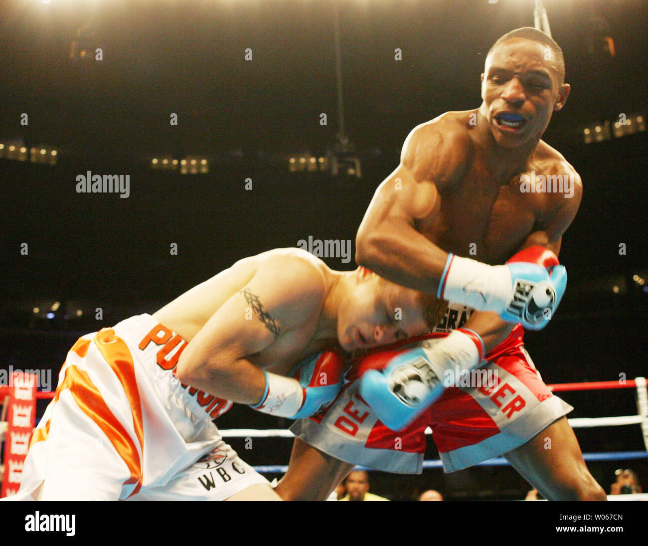 Devon Alexander of St. Louis (R) delivers a blow to the head of Tyler ...