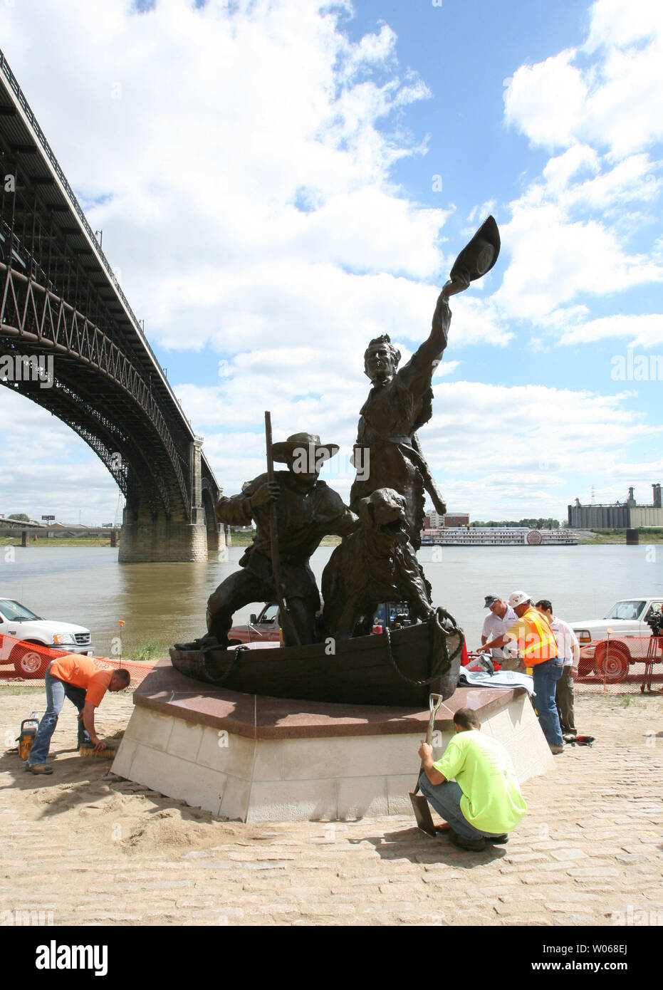 Workers prepare the base of the newly installed Lewis and Clark statue ...