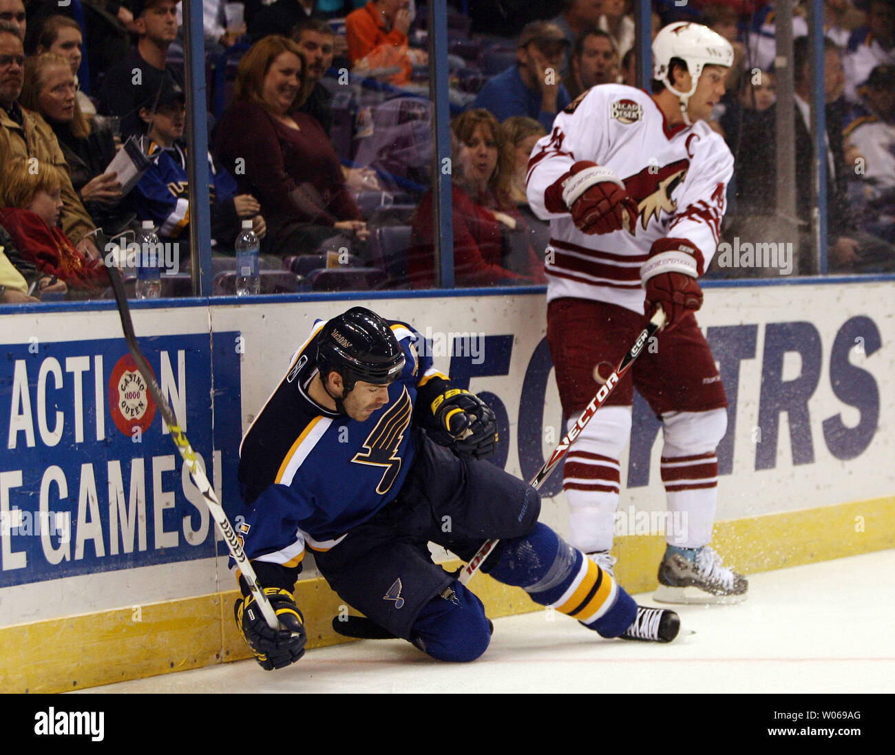 St. Louis Blues Barret Jackman (L) falls to the ice after being upended ...