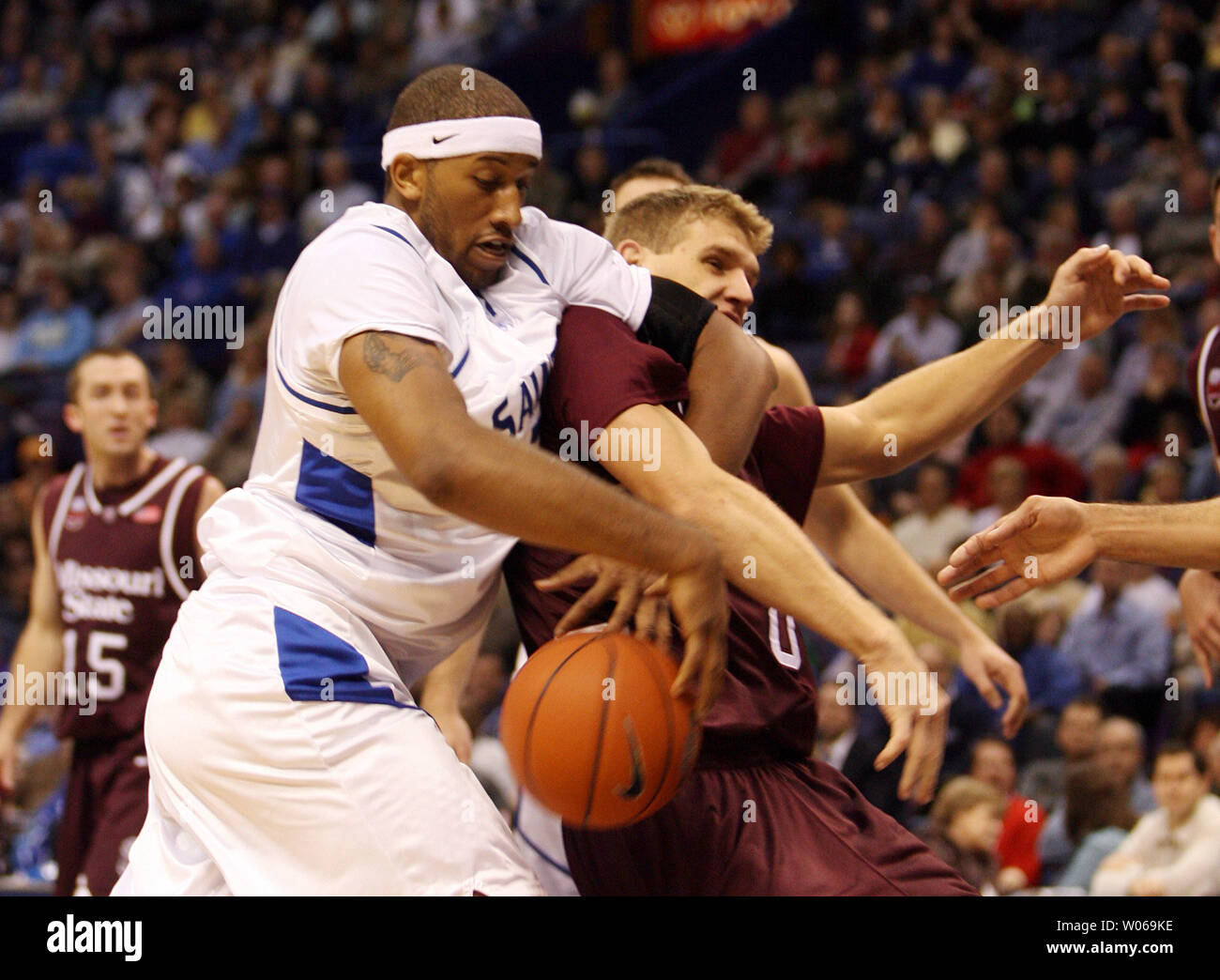 Saint Louis University Billikens Tommie Liddell (L) gets tied up with ...