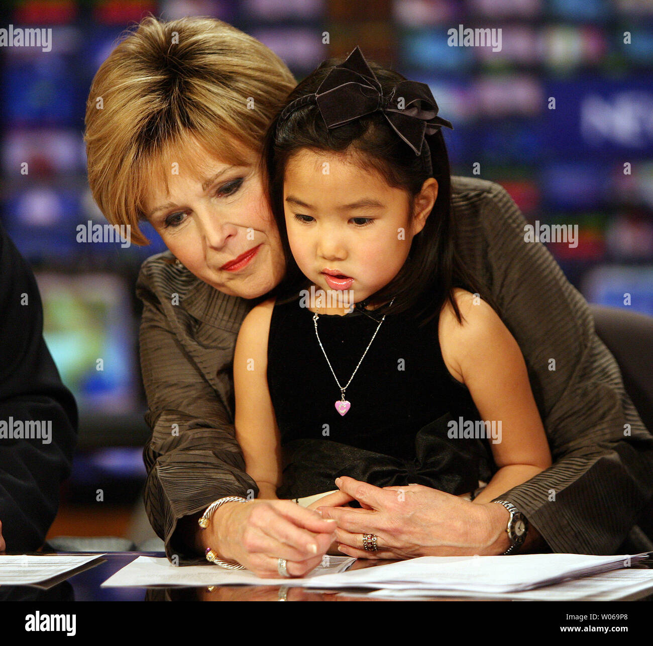 KSDK Newschannel 5 anchor Karen Foss, watches a video piece on adoption ...