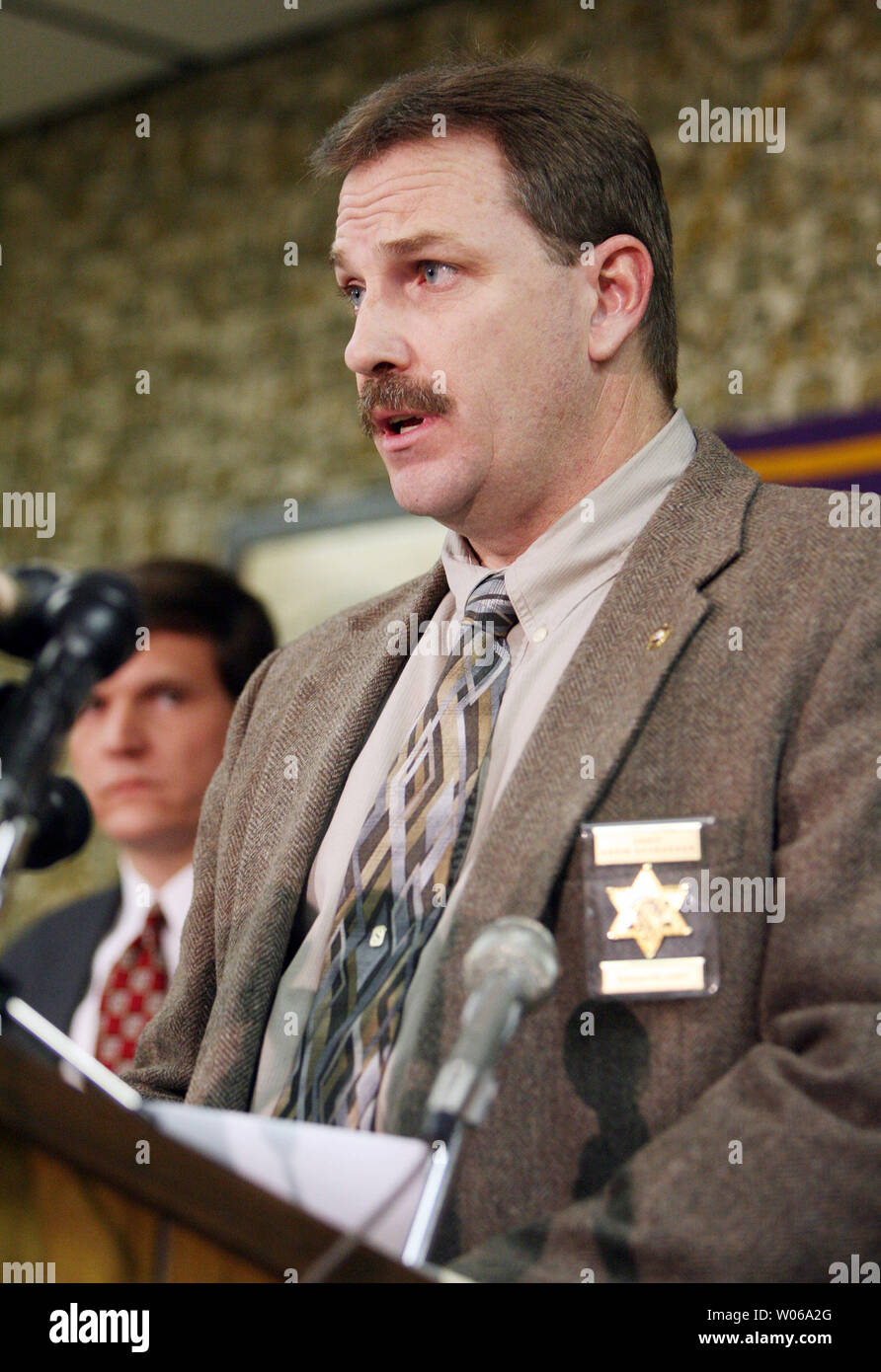 Washington County Sheriff Kevin Schroeder (R) reads new charges against Michael J. Devlin in the ...
