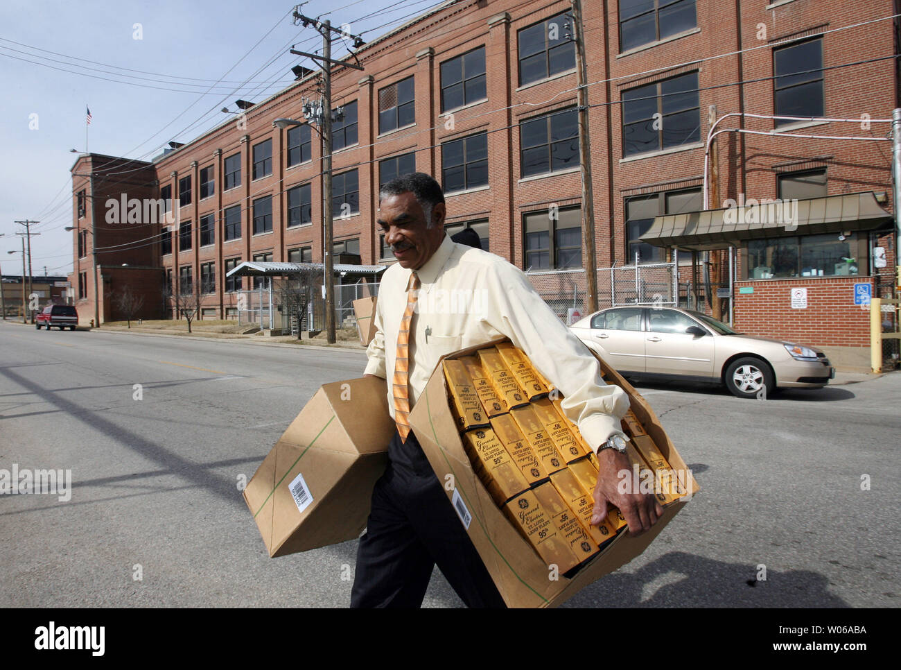 Charles Webb leaves the General Electric Light Bulb Plant with two ...