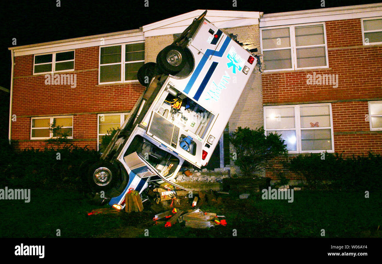 An Abbott ambulance sits on its nose after it flipped and struck an ...