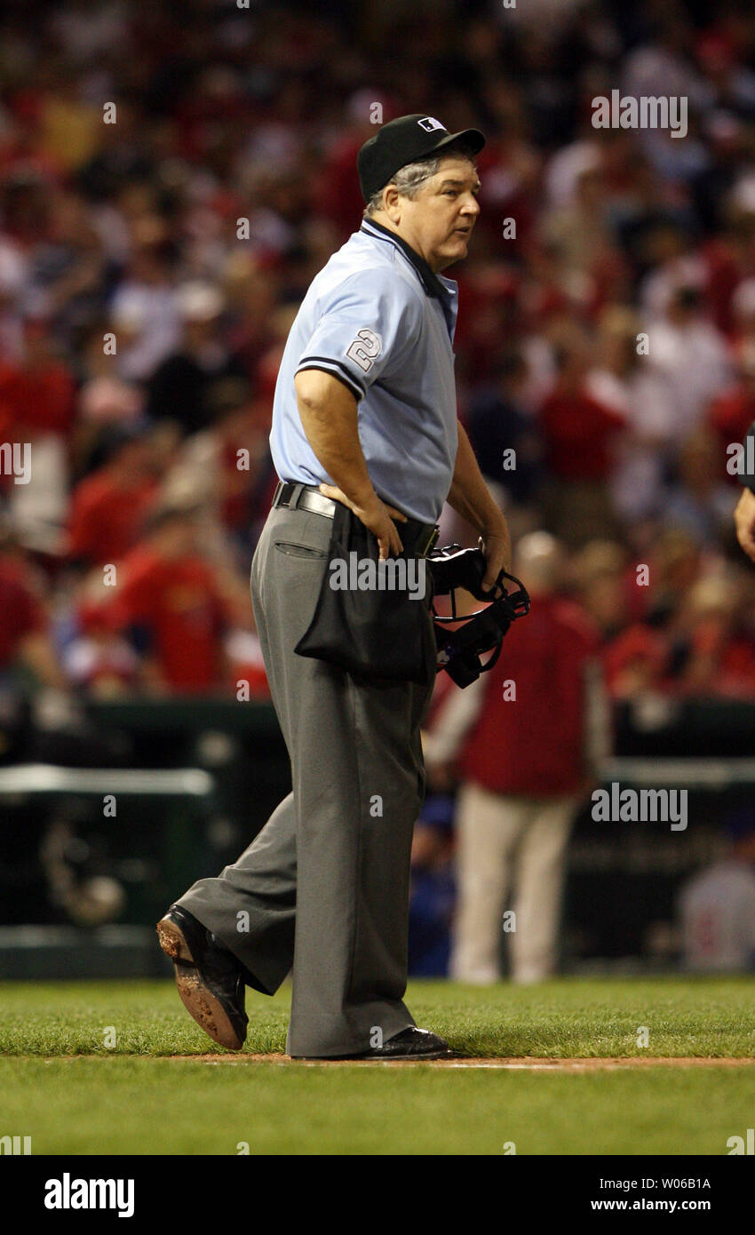 Home plate umpire Jerry Crawford rests his left foot after being hit by ...