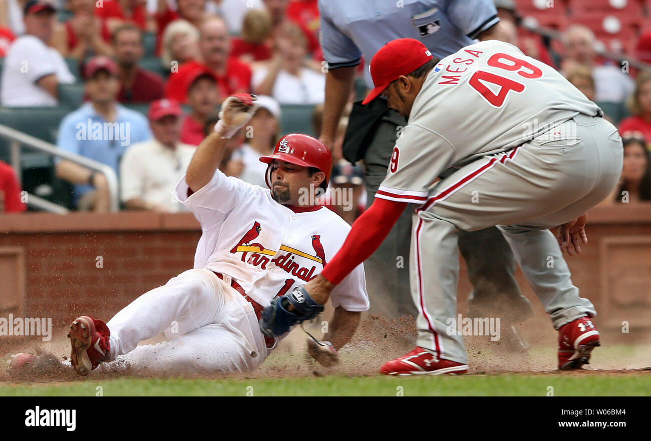 St. Louis Cardinals Aaron Miles slides safely into home plate in front ...
