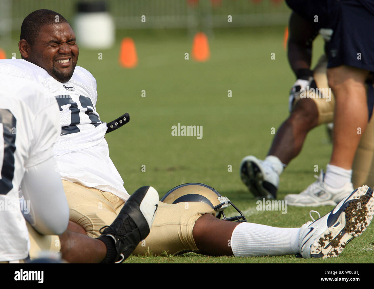 St. Louis Rams Orlando Pace feels the pain while stretching before a ...
