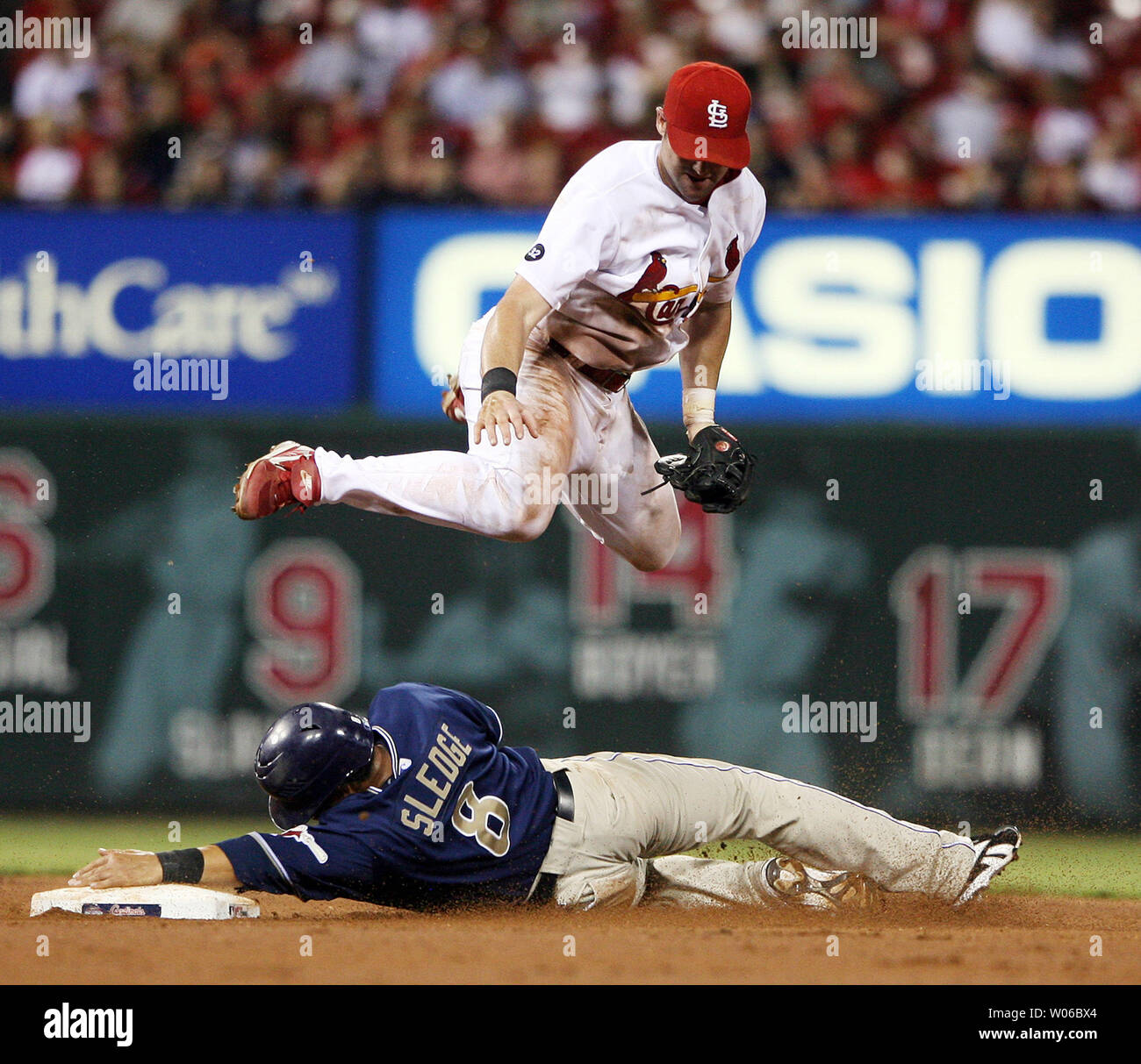 St. Louis Cardinals David Eckstein jumps to avoid the sliding San Diego ...