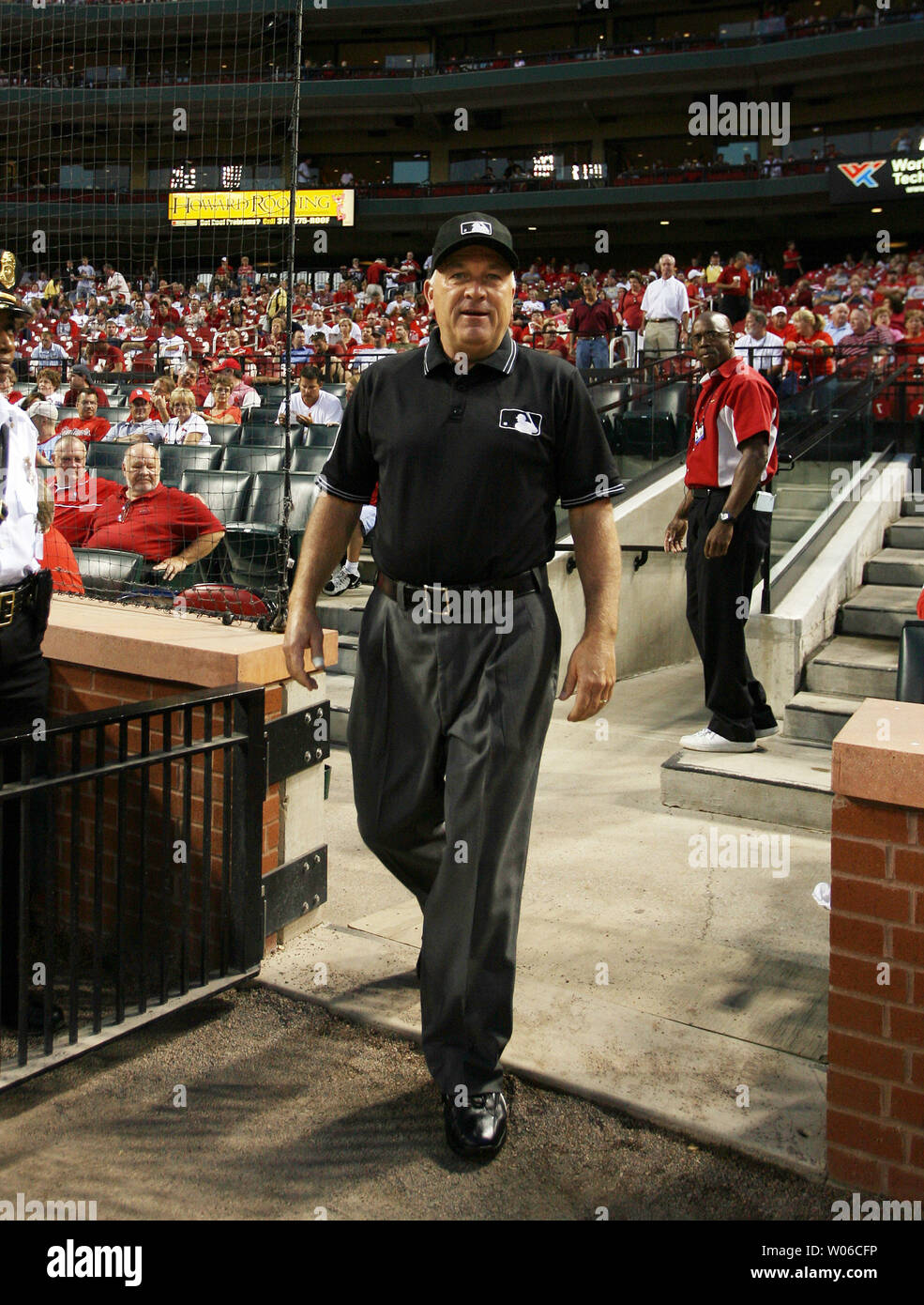 Veteran umpire Ed Montague enters the field to work a game between the ...