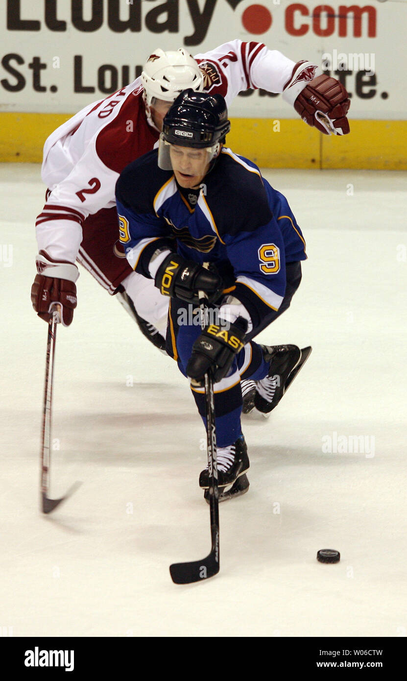 St. Louis Blues Paul Kariya (R) skates past the puck as Phoenix Coyotes ...