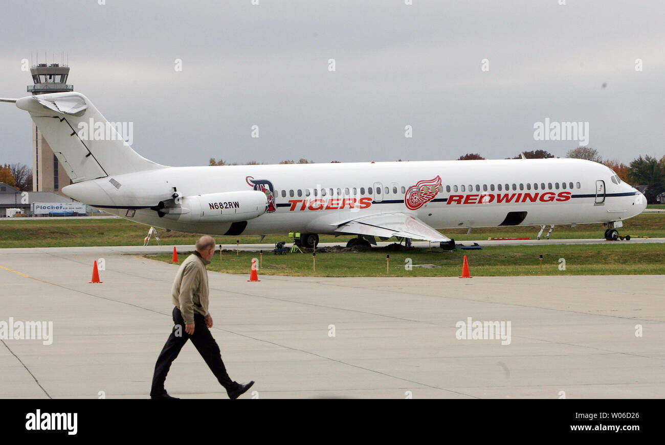 An airport worker walks on the tarmac past the Detroit Red Wings ...