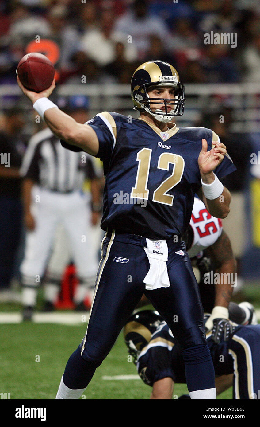 St. Louis Rams quarterback Gus Frerotte gets the football away in the ...