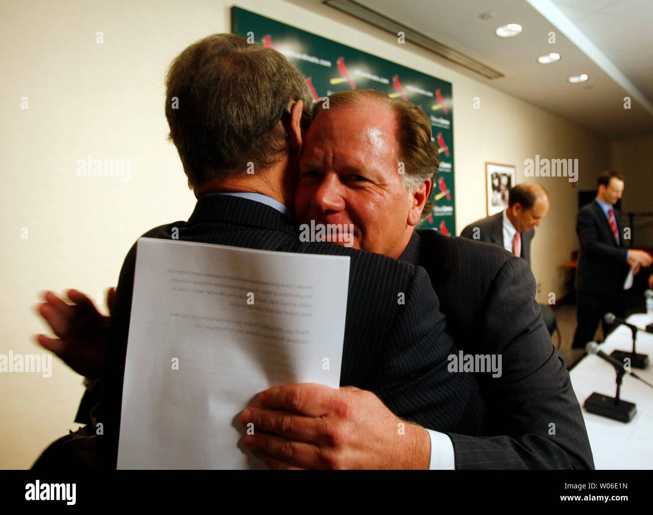 St. Louis Cardinals President Mark Lamping (R) receives a hug from team ...