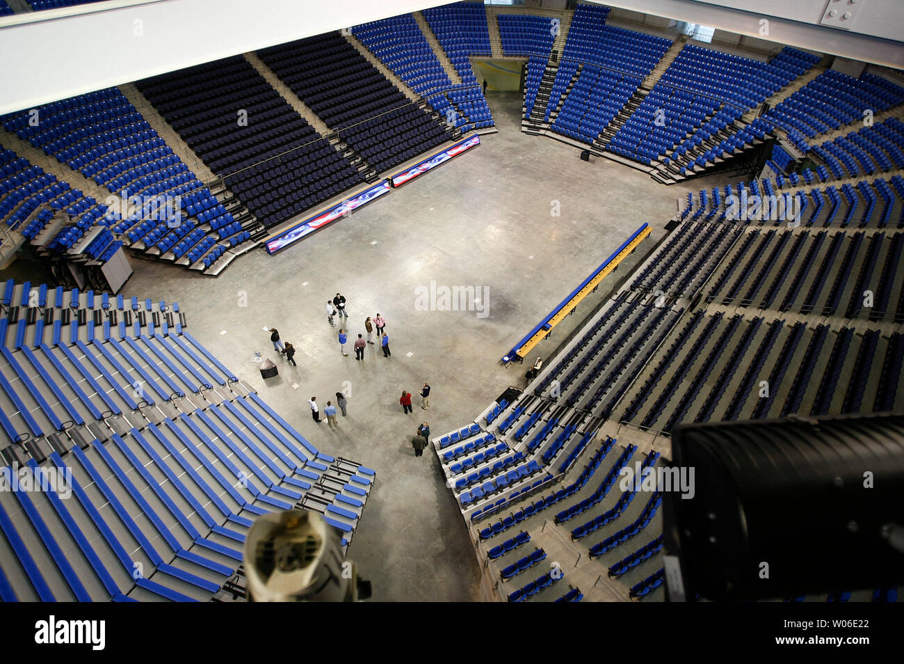 Members of the media roam the area where a new basketball floor will be ...