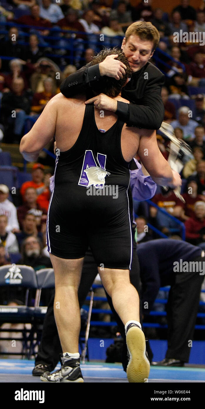 Northwestern head wrestling coach Tim Cysewski jumps into the arms of ...