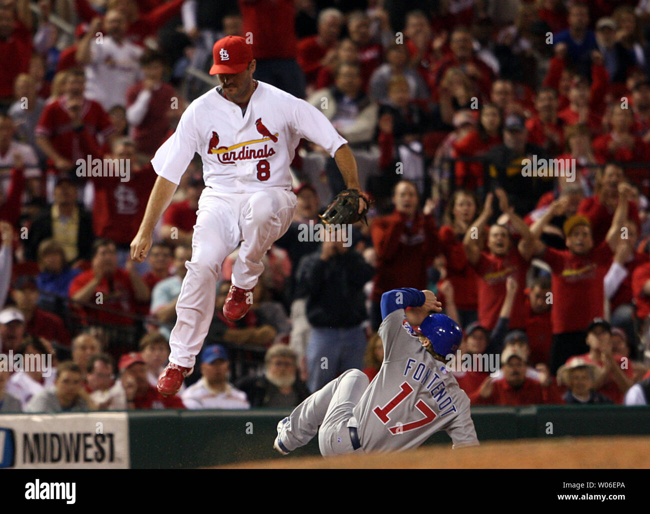 St. Louis Cardinals third baseman Troy Glaus (L) jumps over the sliding ...