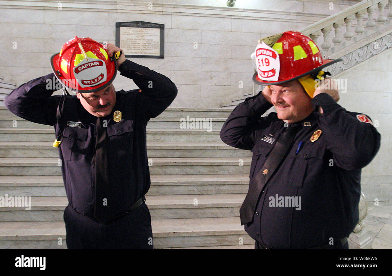 Newly appointed St. Louis Fire Department captains Shaun Rainey (L) and ...
