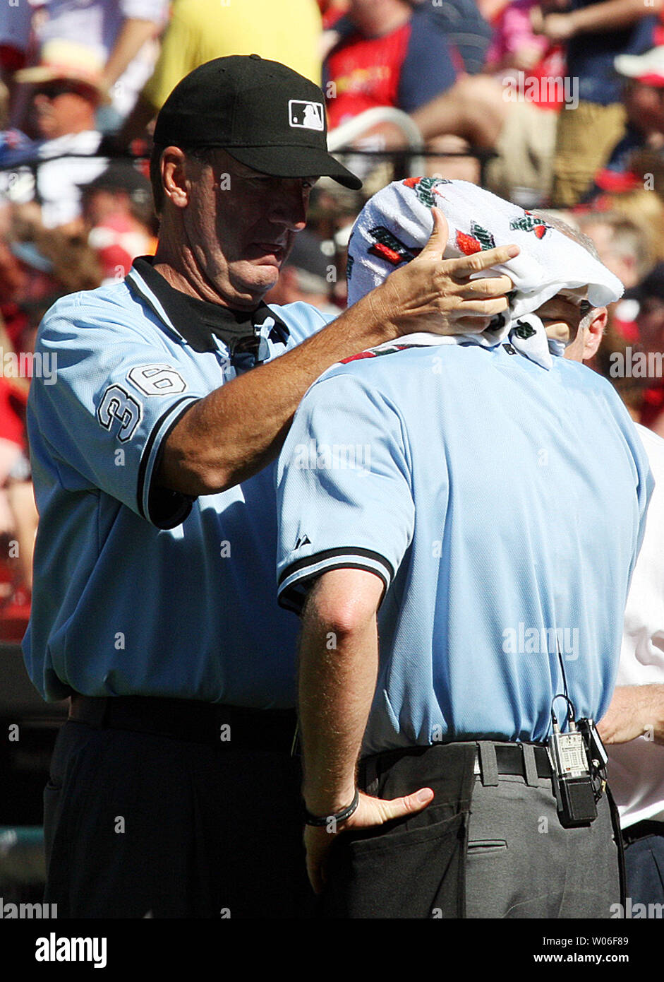 Major League umpire crew chief Tim McClelland (L) helps homeplate ...