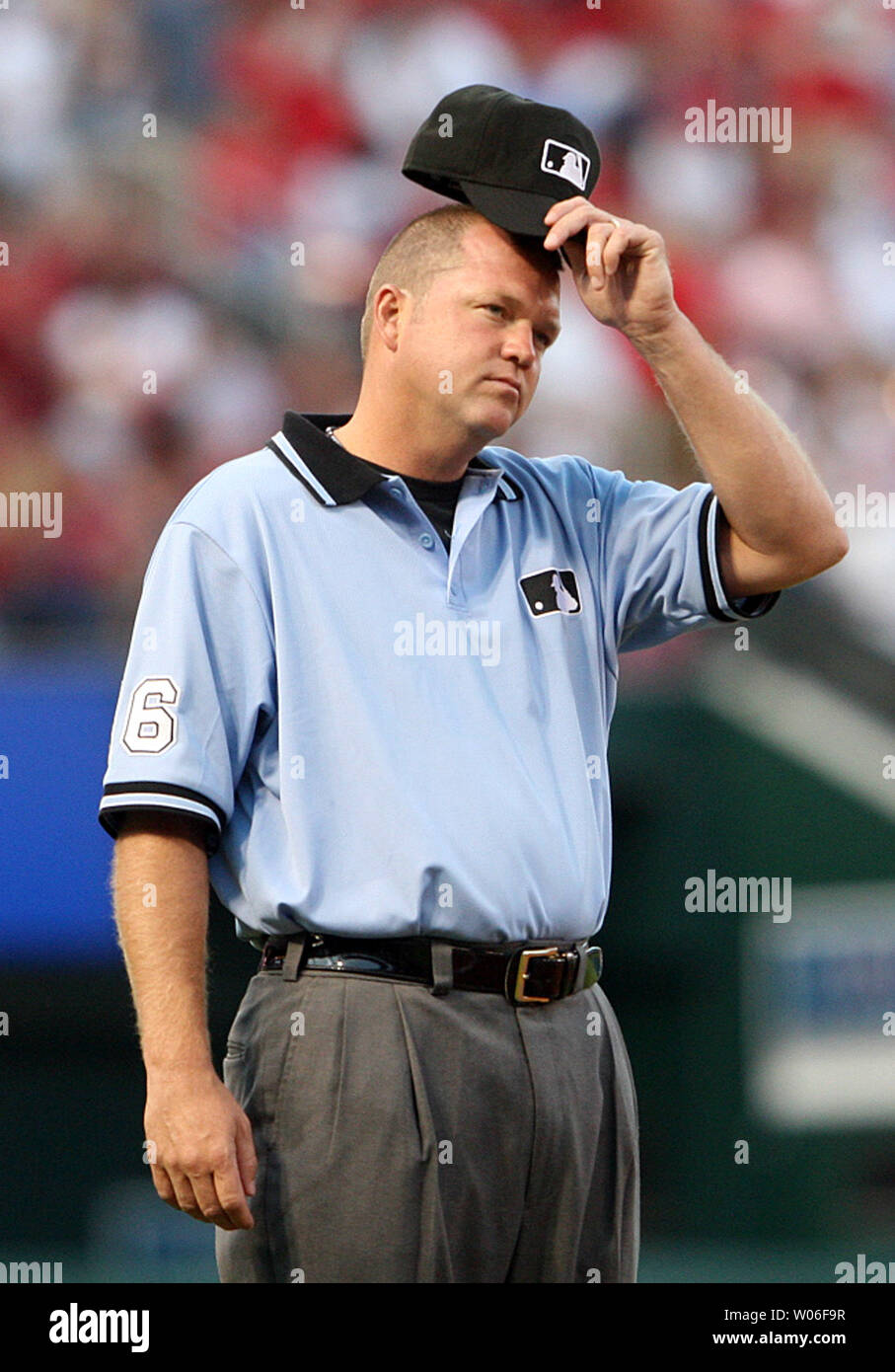 Third base umpire Ron Kulpa adjusts his cap during a game between the ...