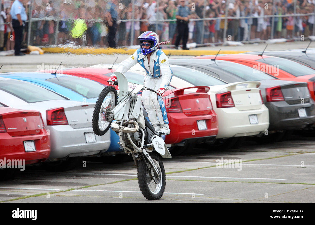 Daredevil Robbie Knievel delights the crowd by riding his motorcycle on ...