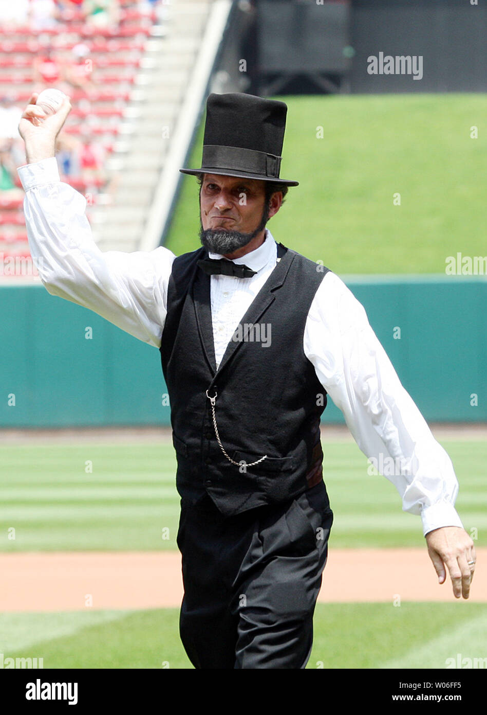 George Buss, who portrays President Abraham Lincoln, throws out a ...