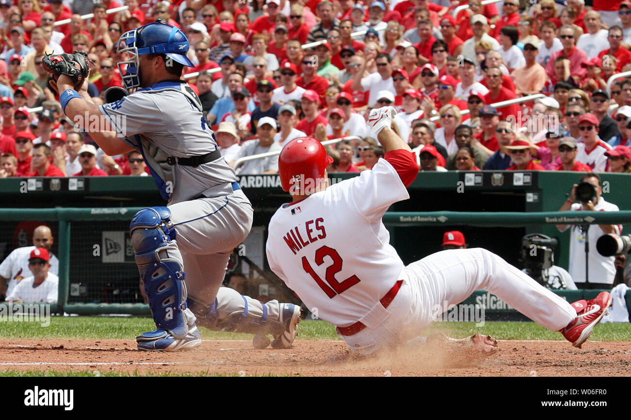 St. Louis Cardinals Aaron Miles slides safely into home plate well ...