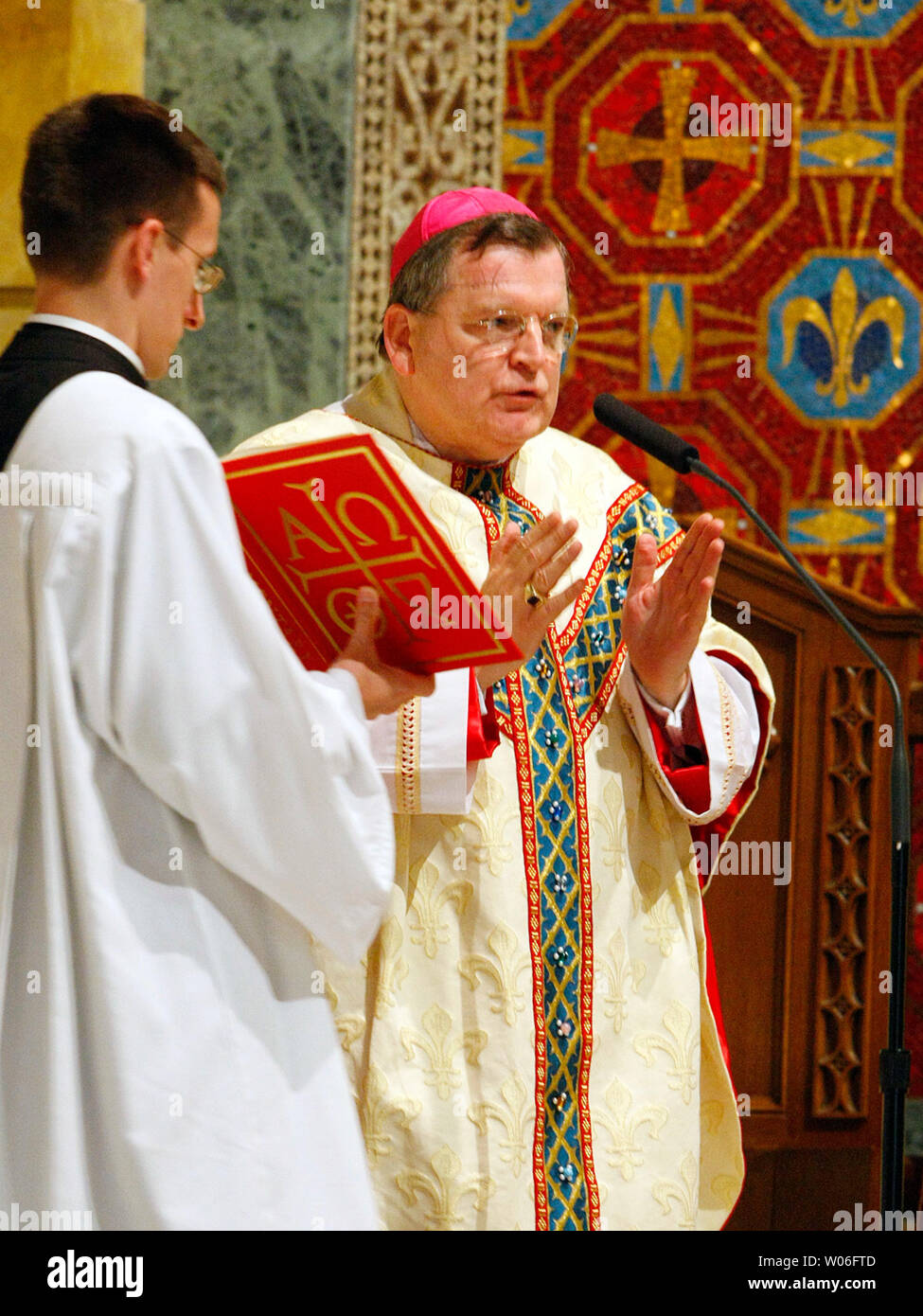 St. Louis Archbishop Raymond Burke (R) speaks to the people during his ...