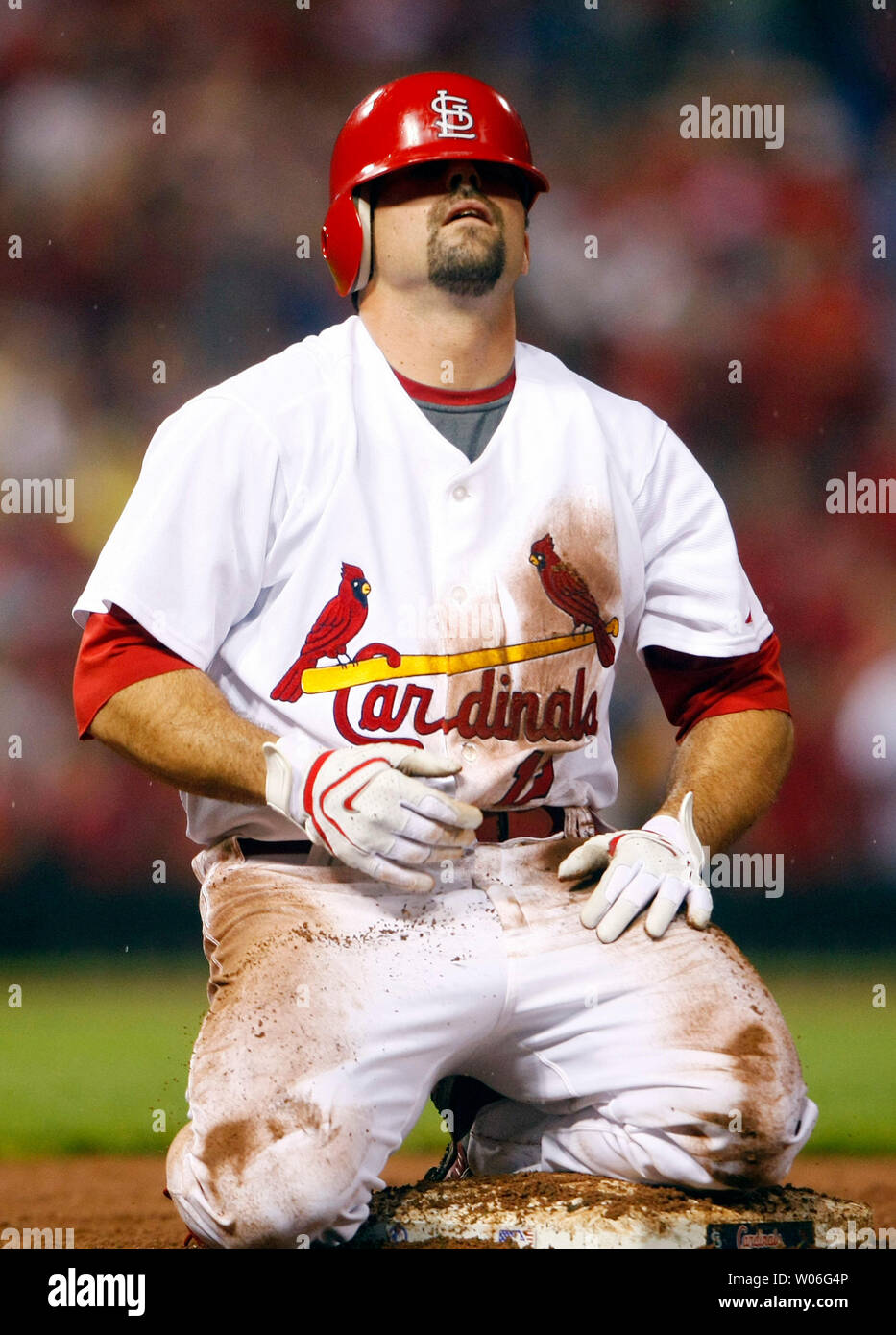 St. Louis Cardinals Aaron Miles looks up at first base coach Dave McKay ...