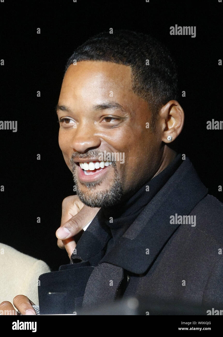 Actor Will Smith smiles to the fans at the red carpet benefit screening ...
