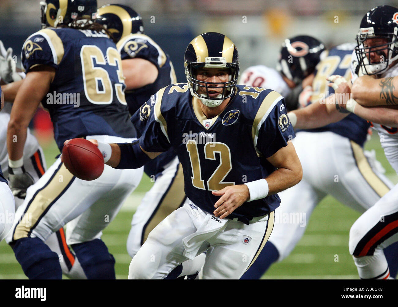 St. Louis Rams quarterback Trent Green looks for a a place to run as he ...