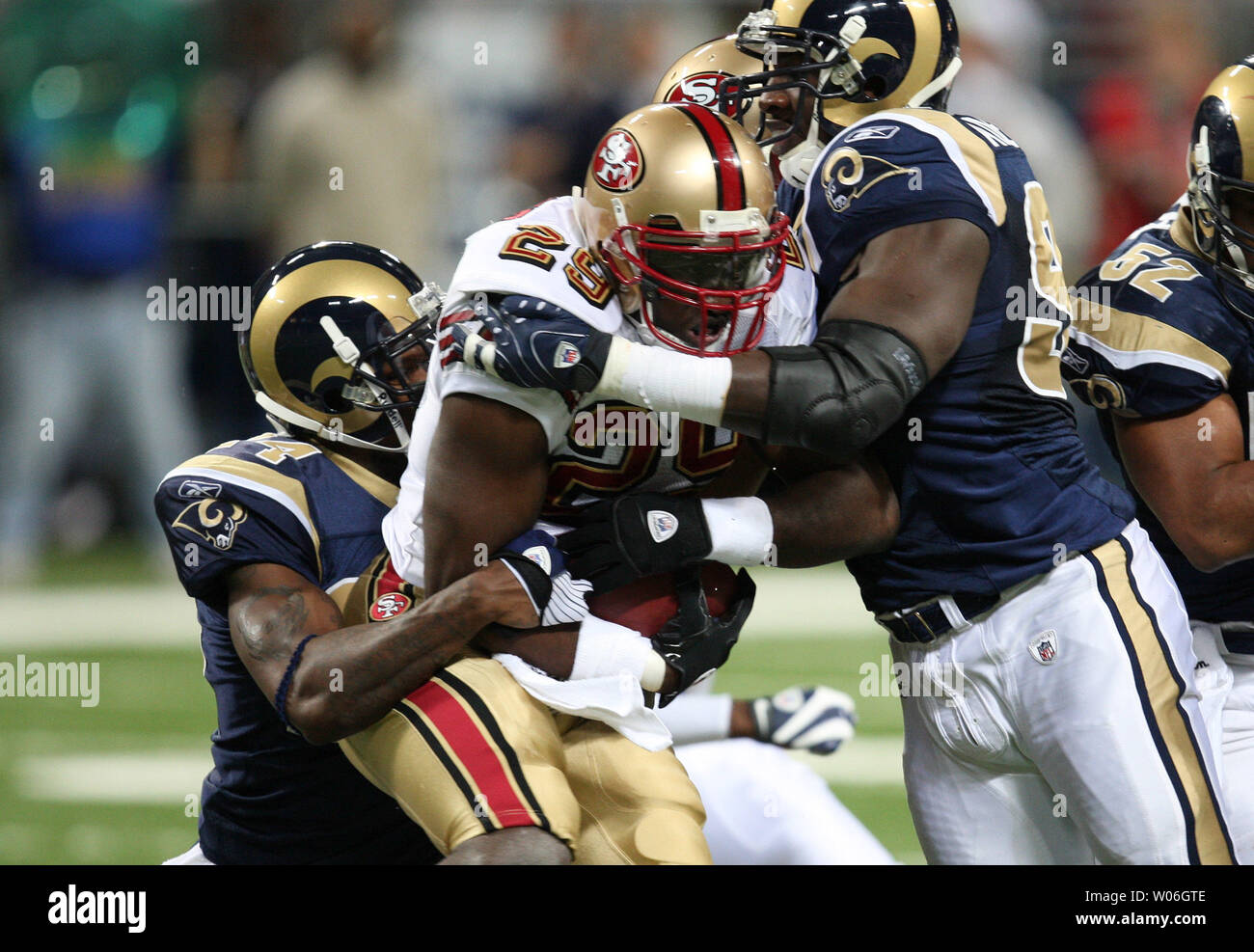 St. Louis Rams Ron Bartell (L) and Victor Adeyanju stop San Francisco ...