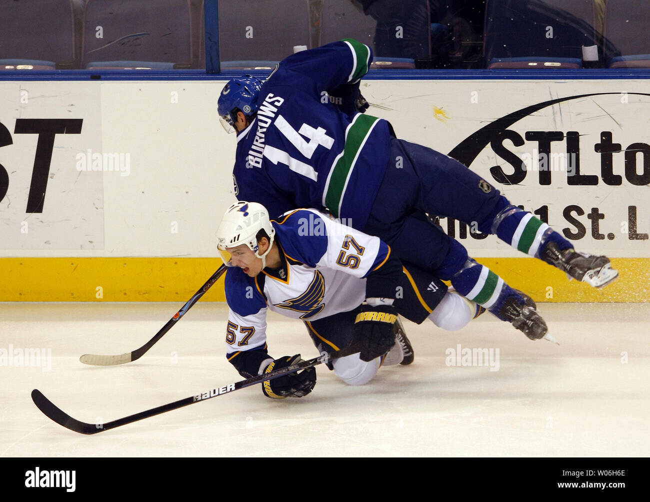 St. Louis Blues David Perron (57) delivers a hip check to Vancouver ...