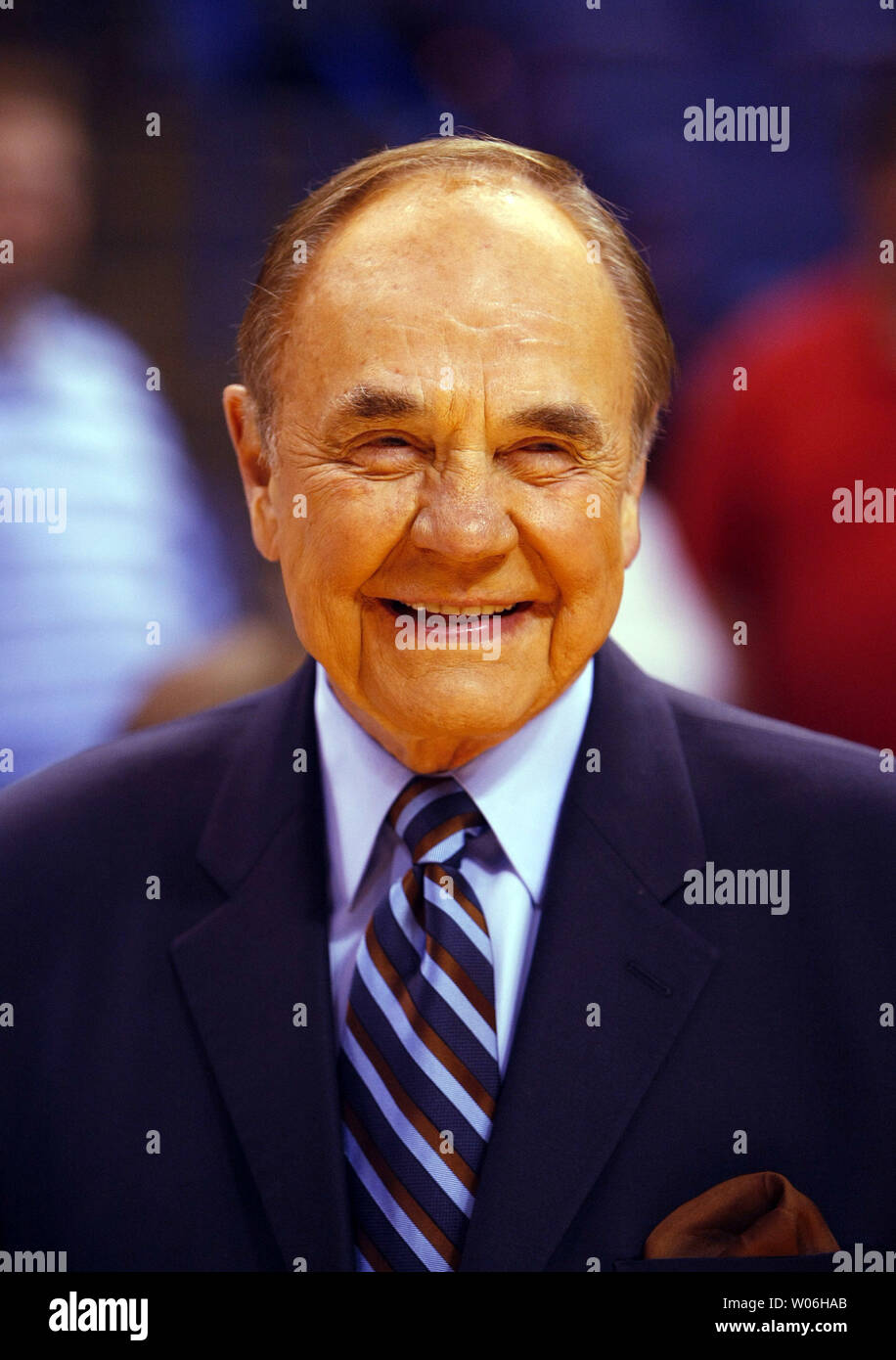 CBS broadcaster Dick Enberg smiles as he talks to friends prior to the ...