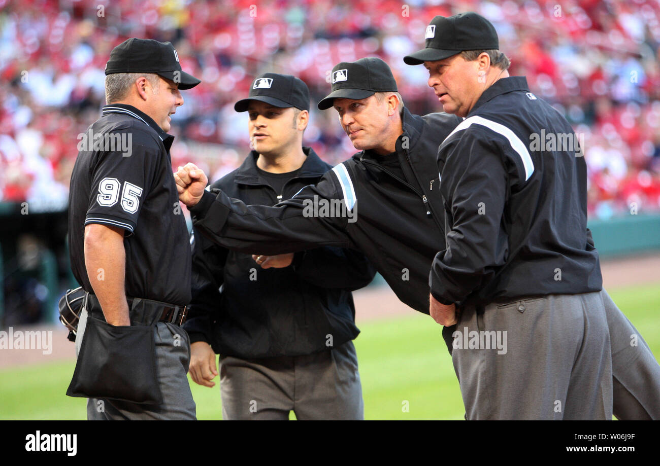 Umpire Jeff Kellogg reaches out to pound the chest protector of ...
