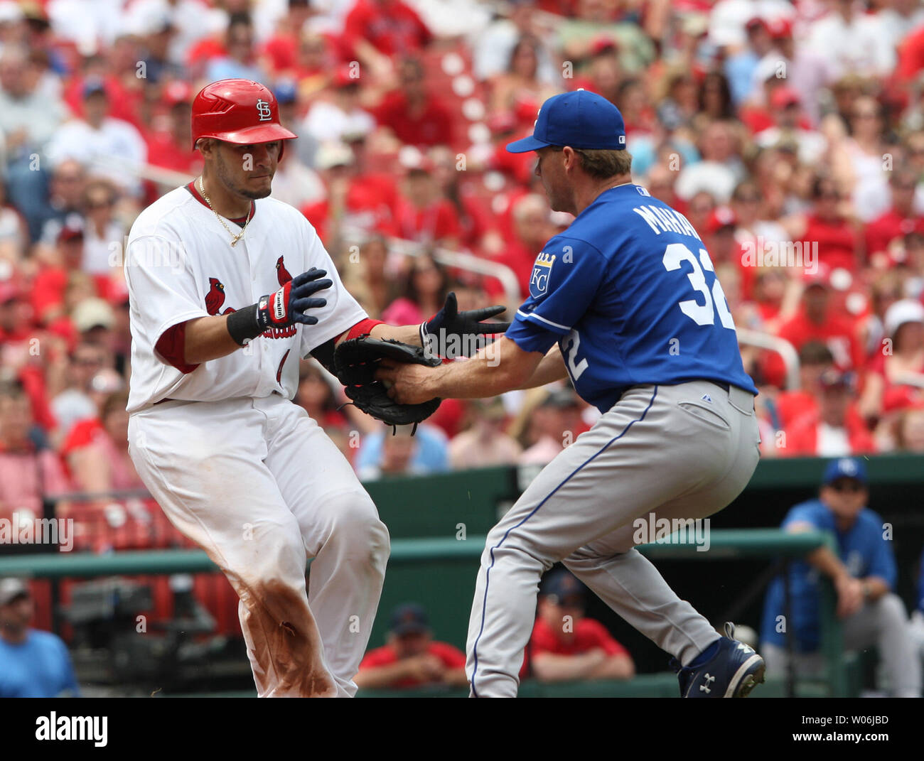 St. Louis Cardinals Yadier Molina (L) is tagged out as he runs to first ...