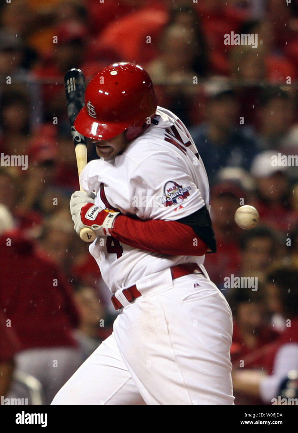 St. Louis Cardinals Yadier Molina turns away as the baseball hits him ...