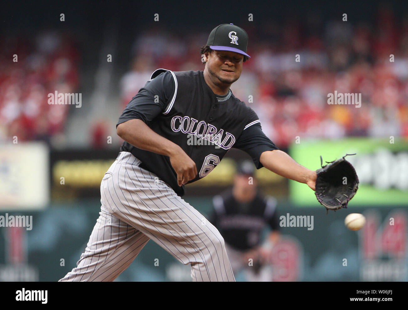 Colorado Rockies pitcher Manny Corpas makes a stab at a baseball hit to ...