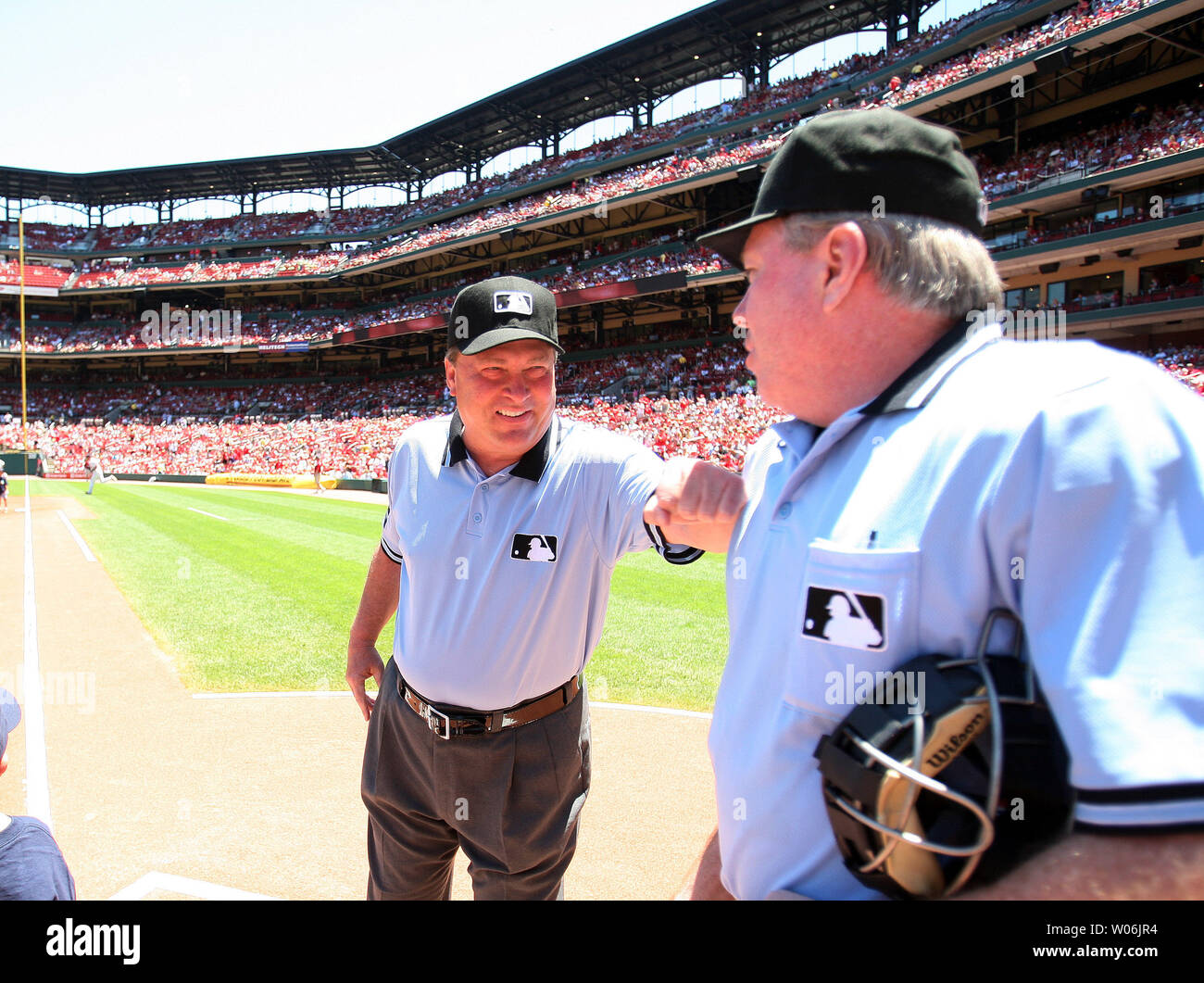 Umpire Gerry Davis (L) gives homeplate umpire Brian Gorman a pat on the ...