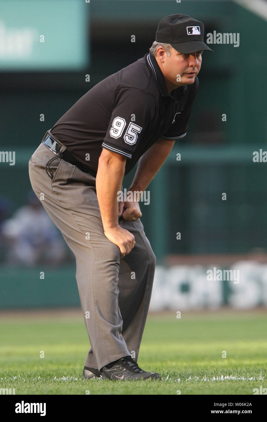 Third base umpire Tim Timmons leans in as the pitch is made in the ...