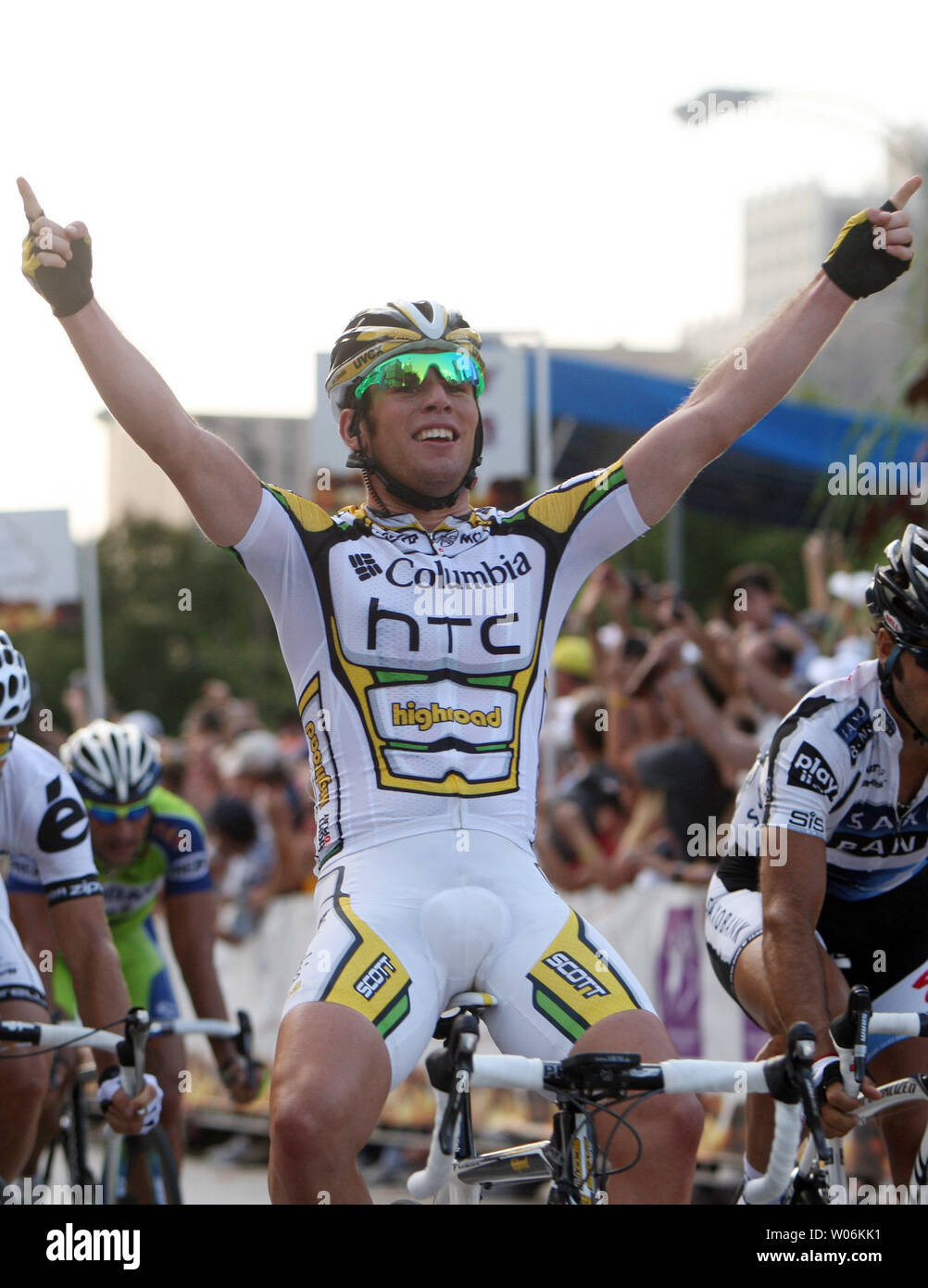 Mark Cavendish of the Columbia-HTC team raises his arms as he crosses ...