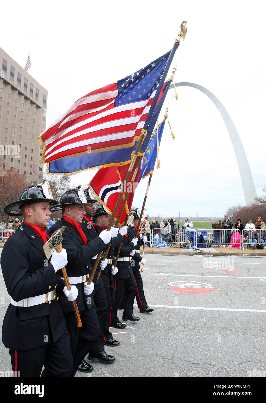 A St. Louis Fire Department Color Guard parades past the Gateway Arch ...