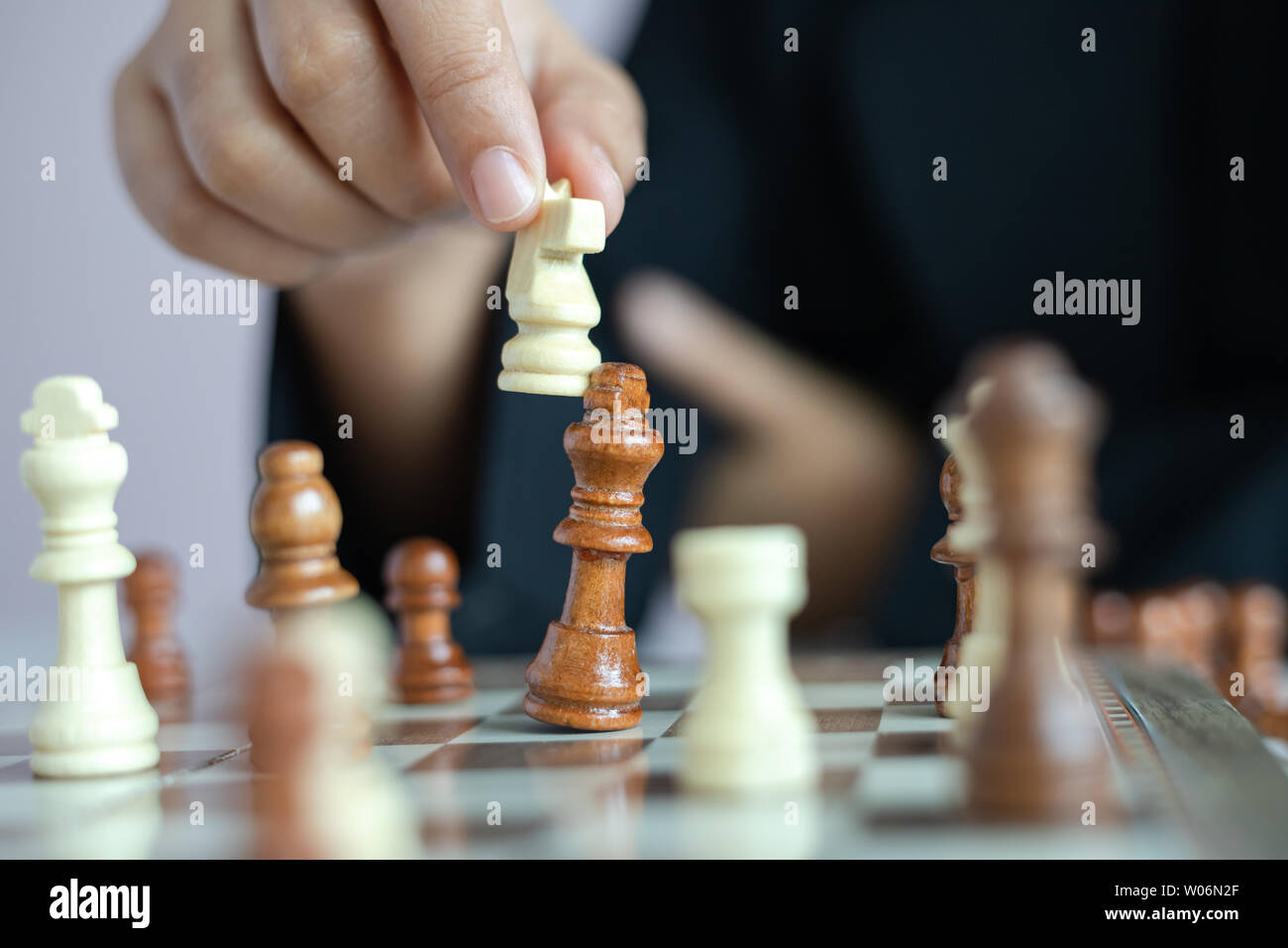 Close up shot hand of business woman playing the chess board to win by ...