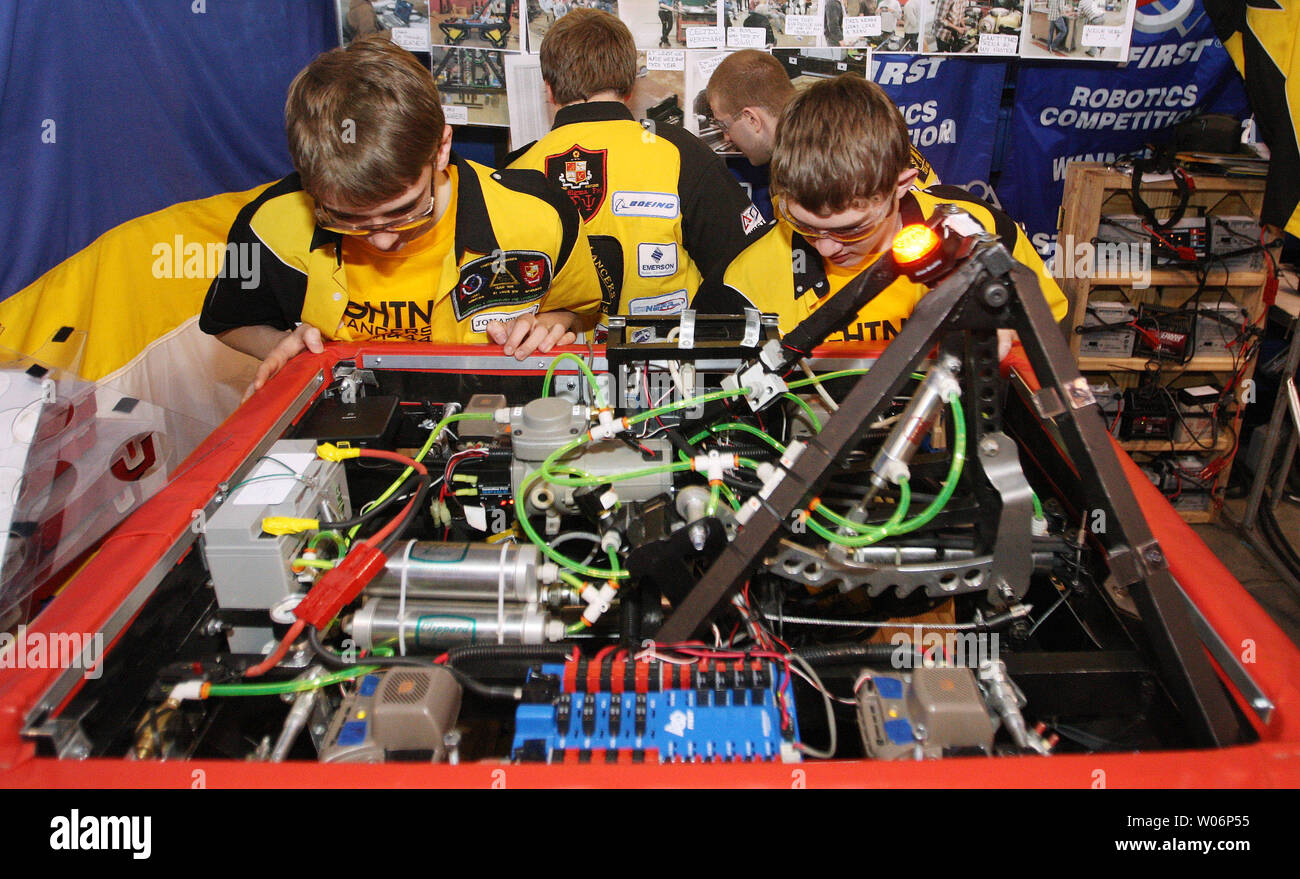 Members of Team 1444 inspect their robotic creation during the FIRST ...