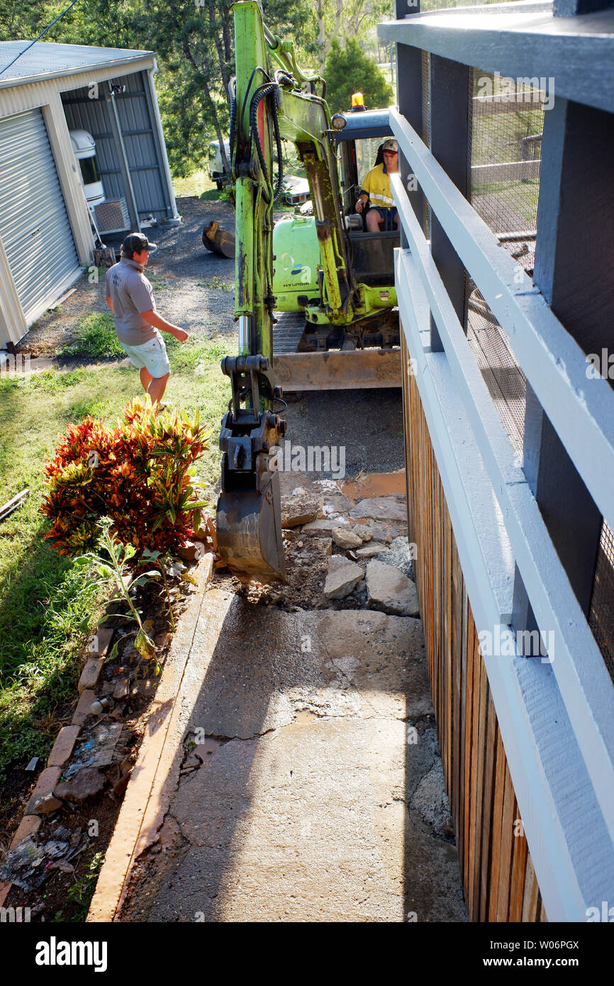 EXCAVATOR BREAKING UP CONCRETE Stock Photo - Alamy