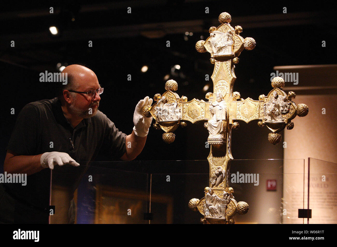 Exibition Designer Whitney Watson makes a small adjustment to a ...
