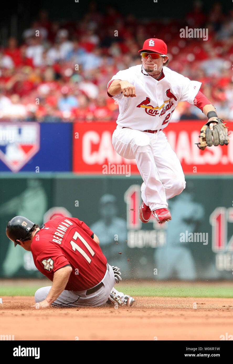St. Louis Cardinals short stop Tyler Greene hops over the sliding ...