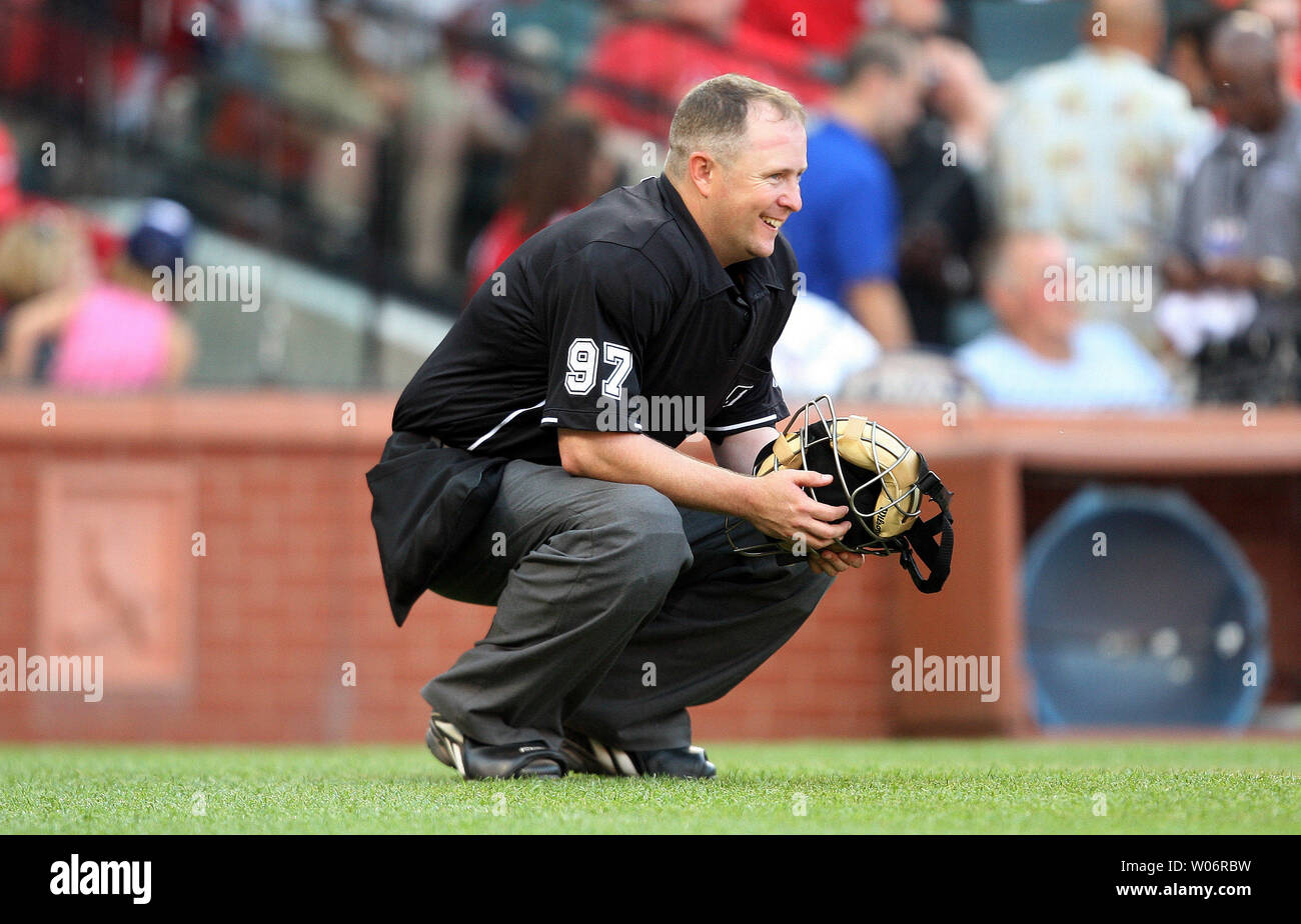 Home plate umpire Todd Tichenor takes a break from the 88 degree ...